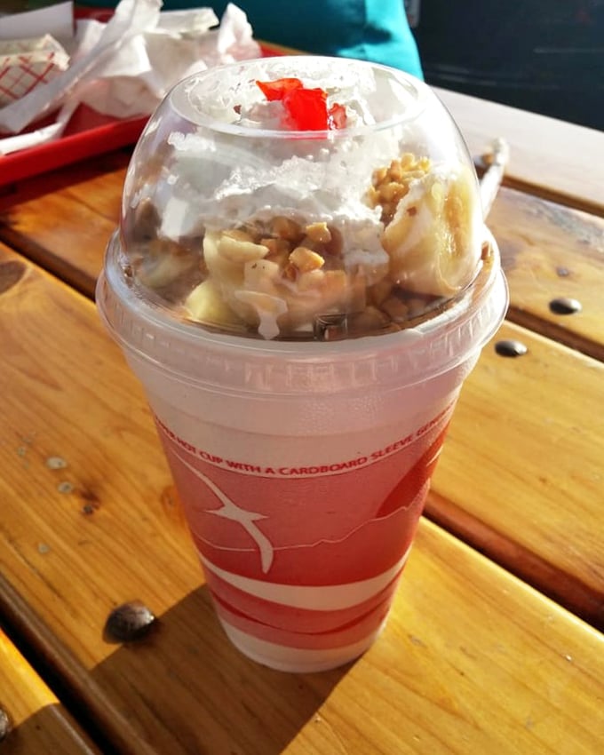 The banana boat sundae—where fruit technically makes this dessert breakfast, right? At least that's what I tell myself while diving into this cloud-topped creation.