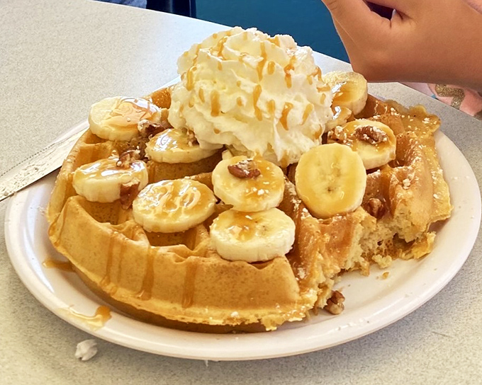 This isn't just a waffle—it's a dessert masquerading as breakfast, where bananas and whipped cream create an alibi for morning indulgence.