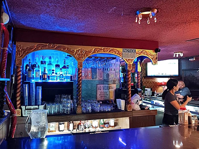 The bar glows like a portal to simpler times, when cocktails were strong, glasses were full, and bartenders remembered your name.