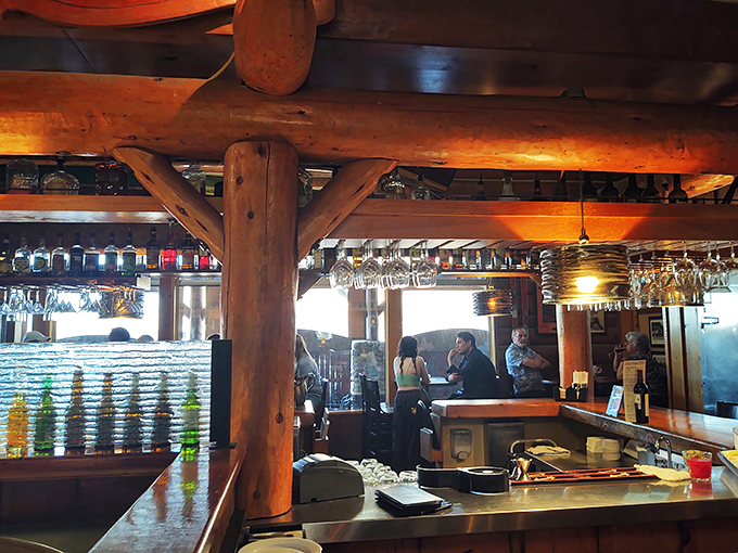 The bar area balances rustic charm with modern efficiency—where mountain lodge aesthetics meet perfectly chilled martinis.