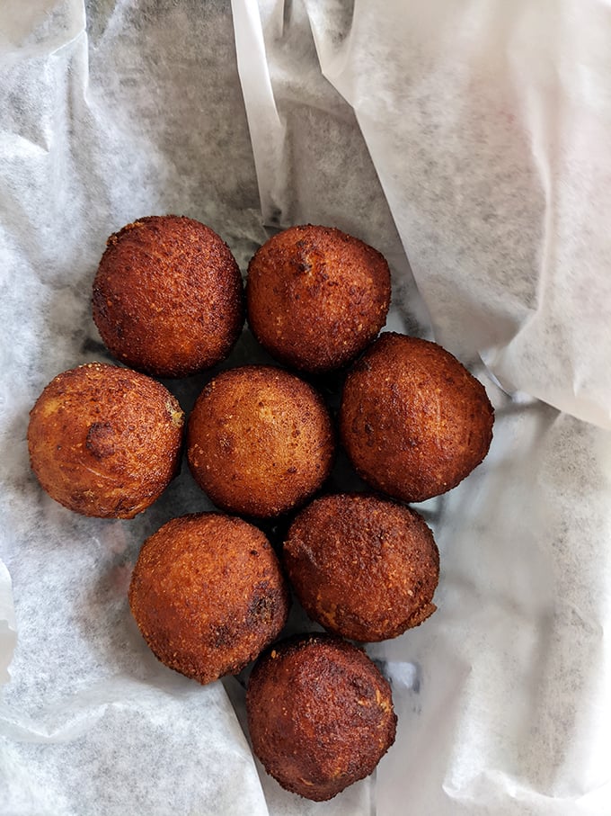 These golden-fried spheres of joy aren't just appetizers—they're edible proof that simple pleasures are often the most satisfying.
