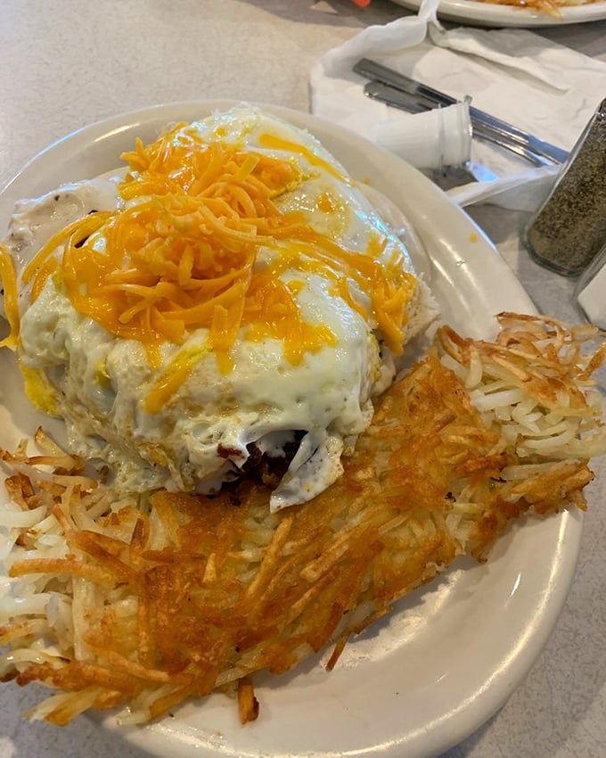 Behold the Biscuit Debris – where gravy, eggs, and cheese create a beautiful breakfast avalanche that requires both fork and strategy.