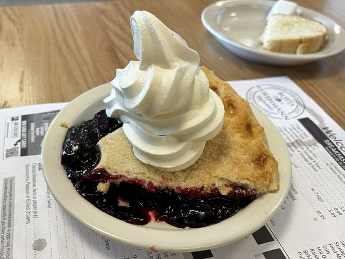 Pie that makes you understand why people write songs about dessert. That whipped cream mountain isn't just decoration—it's essential architecture.