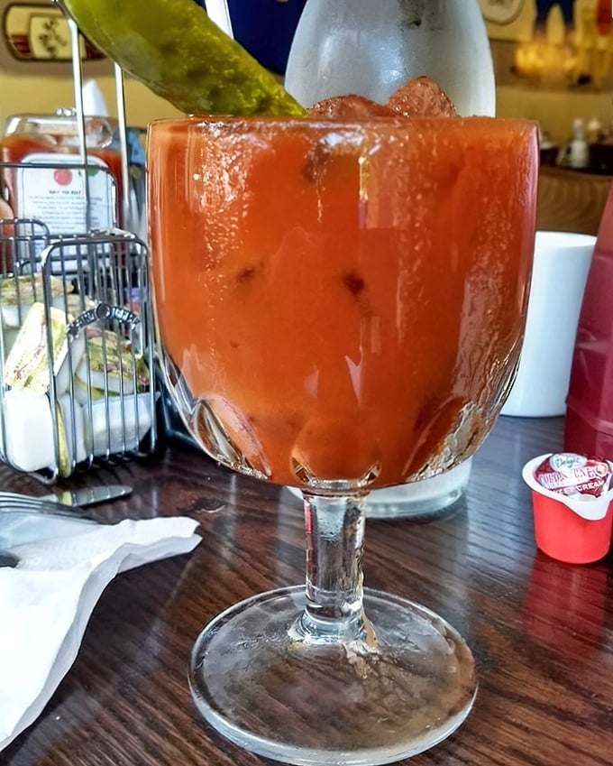 This Bloody Mary isn't just a drink—it's a meal with a mission. That pickle garnish stands tall like a green flag claiming victory over hangovers.