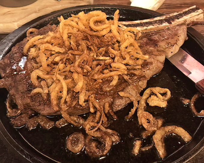 A bone-in ribeye topped with crispy onions – proof that sometimes more really is more, especially when it's this delicious.