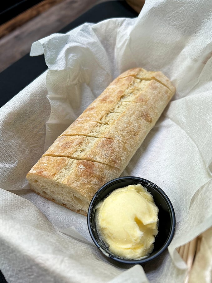 Fresh bread with butter—civilization's perfect starter since forever, executed with the simplicity and respect it deserves.