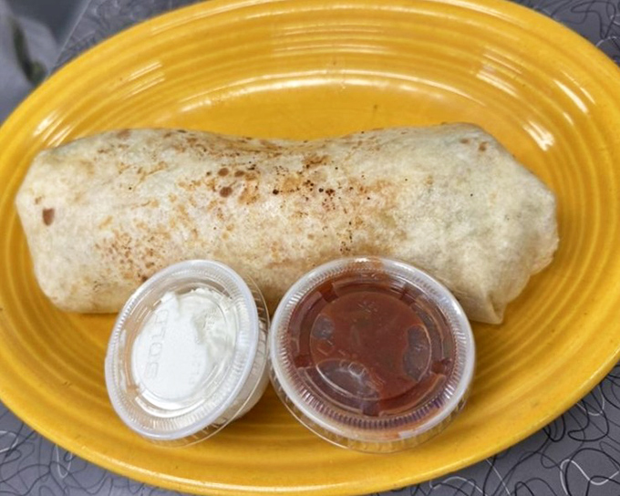 The breakfast burrito—proof that good things come in cylindrical packages. Those dipping sauces are standing by for flavor enhancement duty.