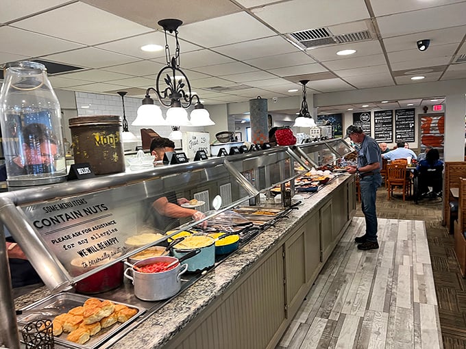 The buffet line – where dreams are made and diets go to die. Steam rises from trays of freshly prepared Southern classics awaiting your plate.