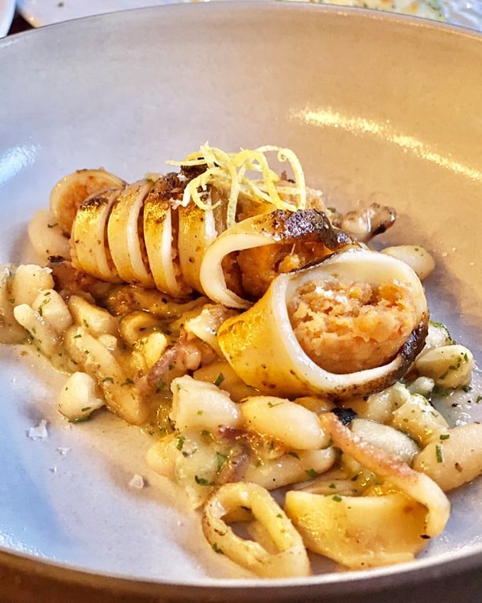 Calamari that didn't come from a freezer bag in this lifetime. Tender rings nestled among beans—seafood that respects its origins.