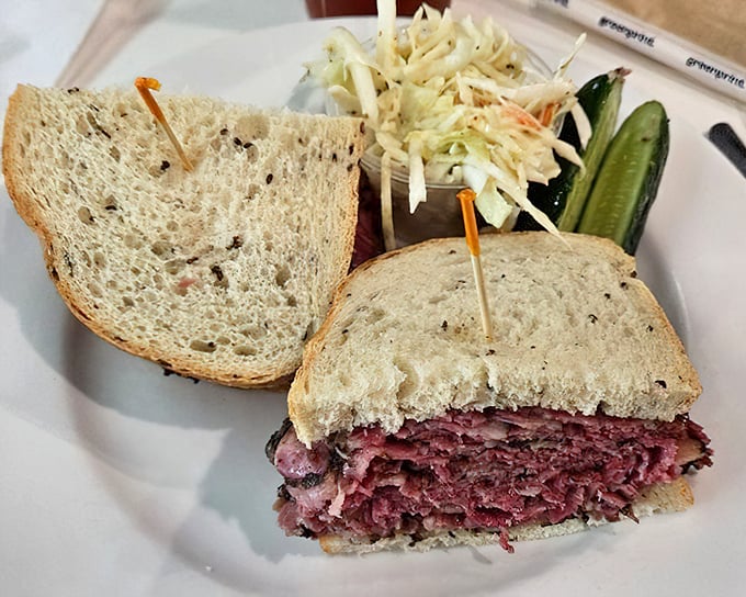 The Carnegie pastrami sandwich—a towering monument to meat artistry that demands both hands and your complete attention.