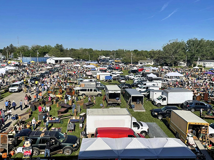 A bird's-eye view reveals the magnificent scale of the market. Cars, tents, and tiny figures create an antique hunter's version of Where's Waldo.