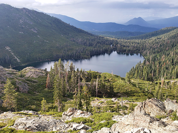 Castle Lake mirrors the surrounding wilderness in perfect stillness. This alpine gem offers swimming in summer and ice fishing in winter—nature's seasonal mood swings.