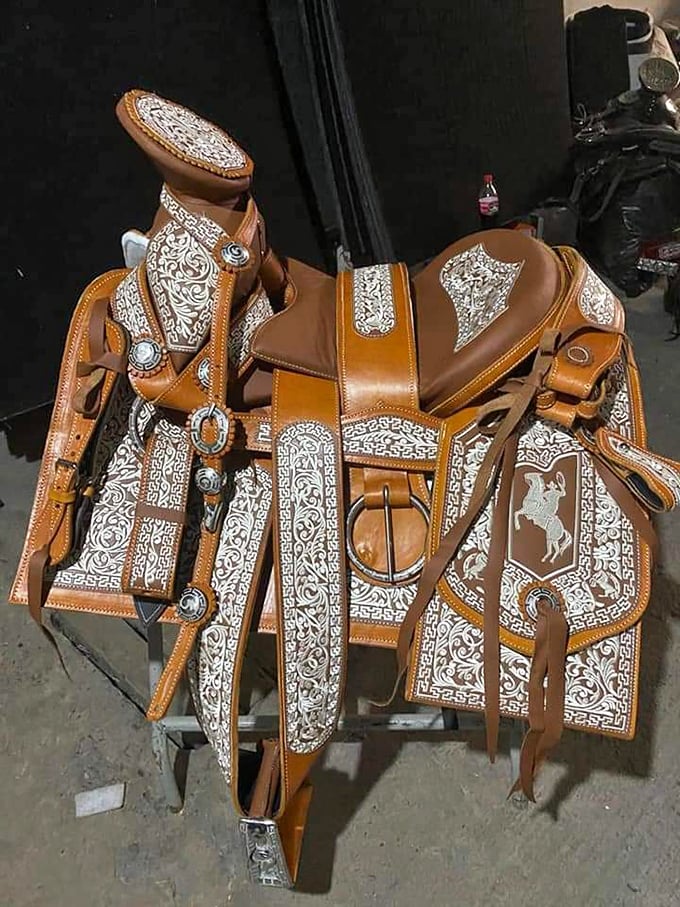 A saddle fit for a silver screen cowboy, its intricate silverwork telling stories of dusty trails and frontier adventures yet to come.