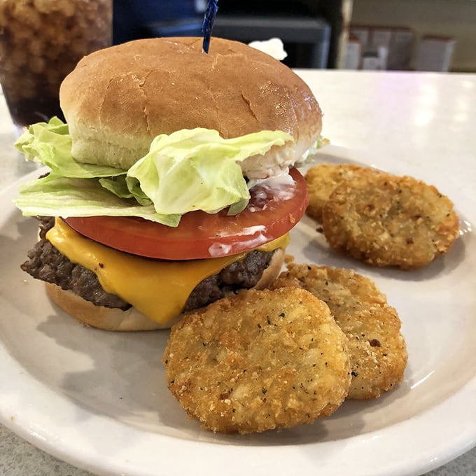 This cheeseburger with potato cakes is diner perfection – no foam, no tweezers, just honest-to-goodness satisfaction on a plate.