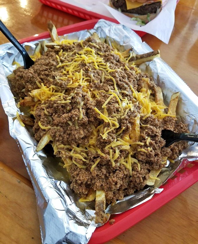 Chili cheese fries that require both a fork and a moment of silent appreciation—the ultimate shareable that nobody actually wants to share.