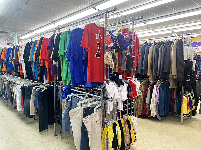 The clothing racks—where vintage Wizards jerseys hang next to business casual staples, creating the world's most democratic department store.