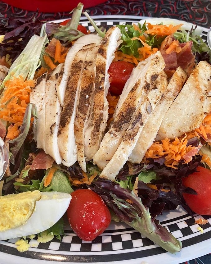 This isn't just a salad—it's a protein-packed landscape where grilled chicken, fresh vegetables, and hard-boiled egg create a nutritious escape route from burger guilt.