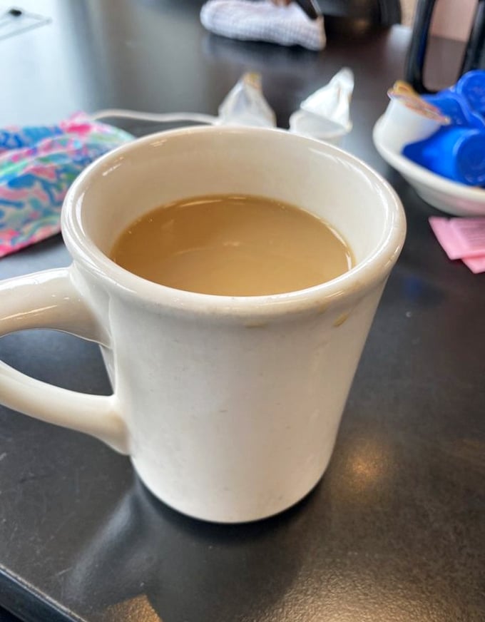 The humble diner coffee mug—holding the elixir that transforms zombies into humans every morning across America.
