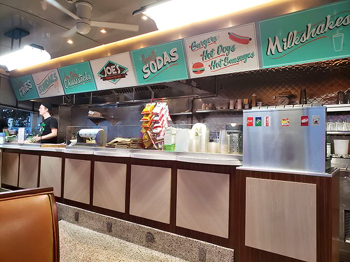 The counter beckons with its retro signage promising classic American delights – milkshakes, hot dogs, and sodas that taste like childhood memories.