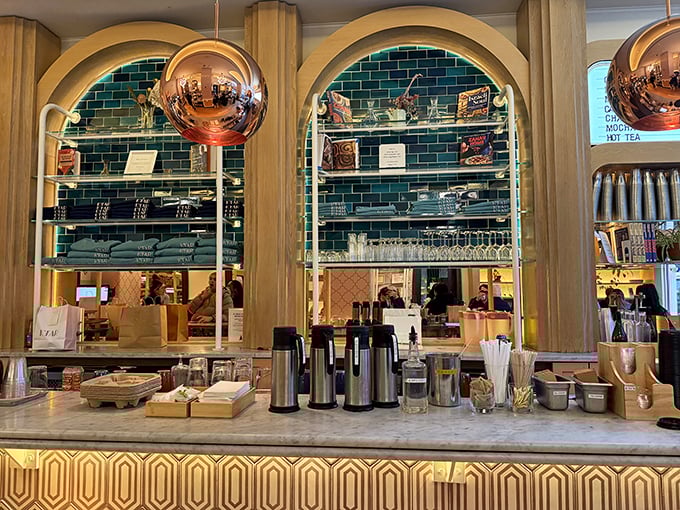 The counter's honeycomb pattern and elegant arches transform a simple coffee order into a moment of unexpected beauty in your otherwise ordinary day.