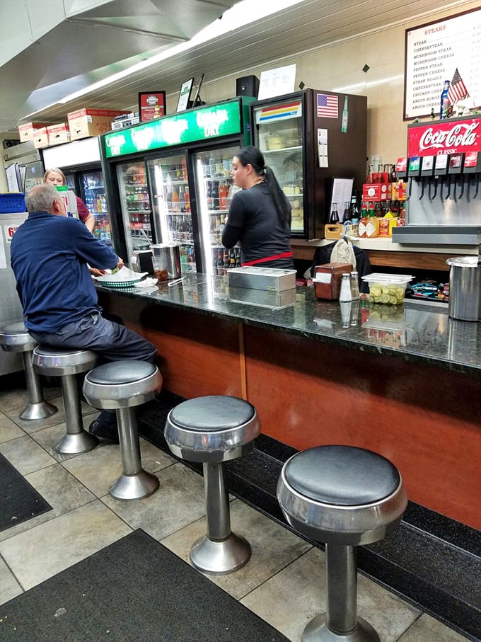 The diner counter—where regulars perch and newcomers learn the ropes. Those silver stools have heard decades of Philly stories.