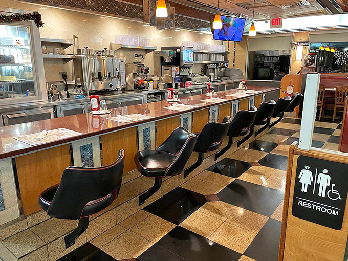 Counter seating – where solo diners become regulars, watching short-order ballet while morning news murmurs from the mounted TV.
