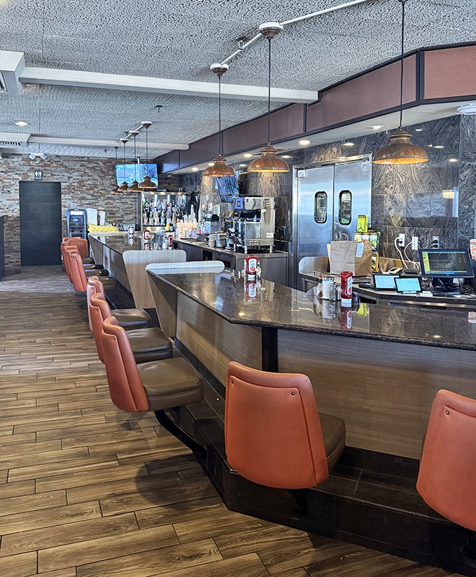 The counter where friendships form over shared appreciation for expertly prepared comfort food classics daily.