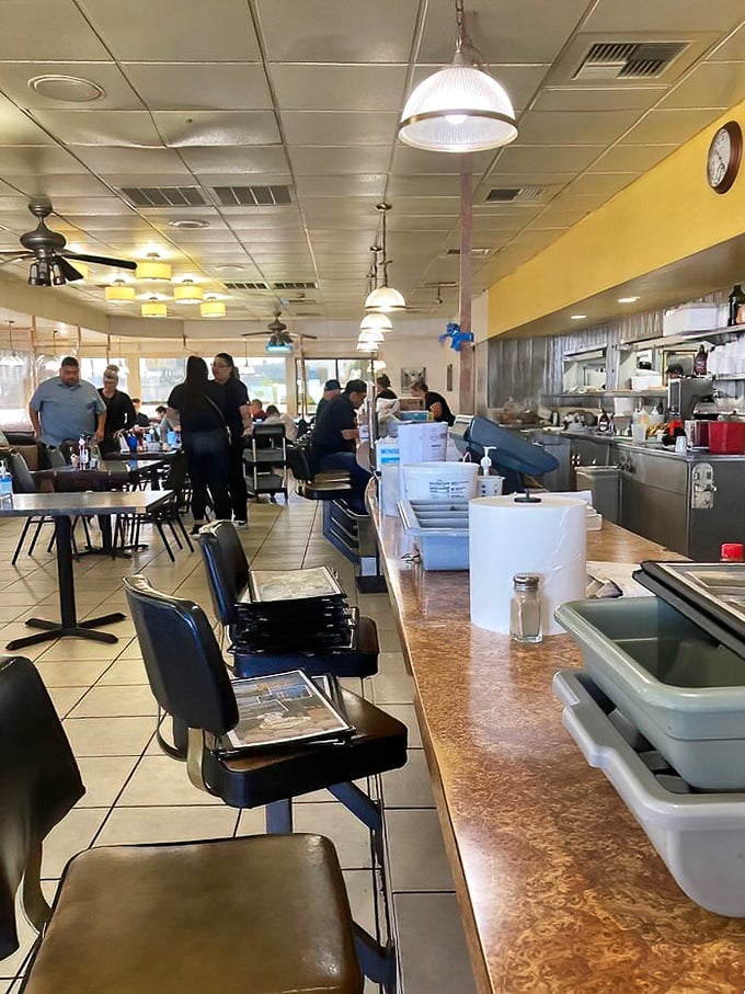 Counter culture at its finest – where regulars perch like breakfast connoisseurs, watching their meals come to life just feet away.