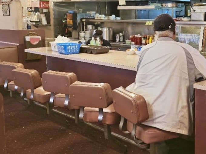 The counter seats—where solo diners become regulars and the coffee never stops flowing. Pure diner poetry in motion.