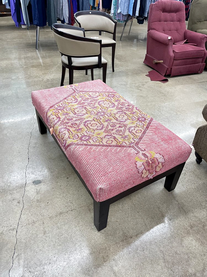 This pink ottoman didn't end up here by accident—someone's spouse finally won the "that doesn't match anything we own" argument.