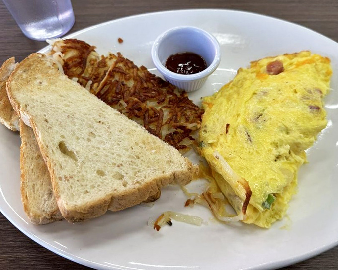 This isn't just an omelet—it's a perfectly executed morning masterpiece with toast standing by for essential yolk-sopping duties.