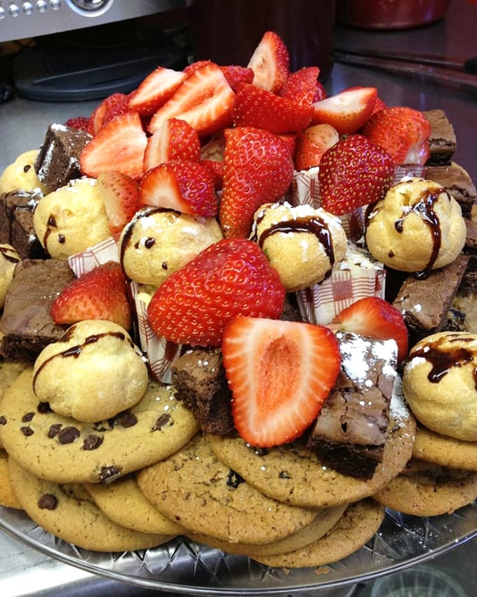 Not just dessert—it's a celebration on a plate. Cookies, brownies, and fresh strawberries arranged with the kind of generosity that makes you feel instantly welcome.