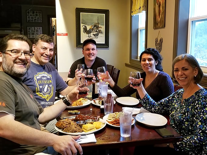 Happiness is friends gathered around a table of barbecue. Those raised glasses aren't just toasting drinks—they're celebrating the universal language of good food.