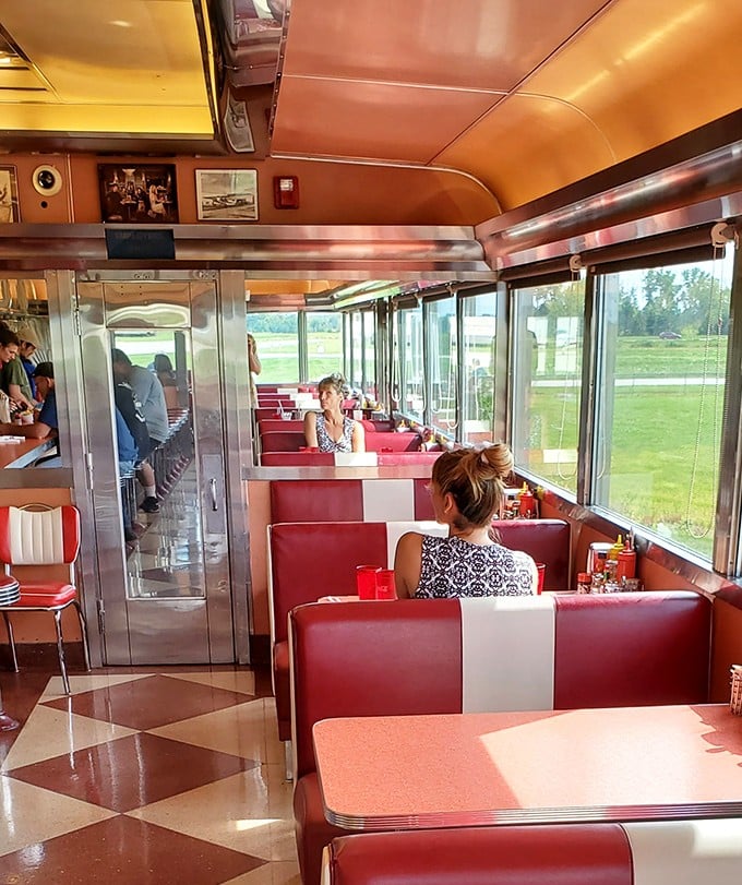 Sunshine streams through windows as diners enjoy the view. Breakfast with a side of runway watching—only in Port Clinton.