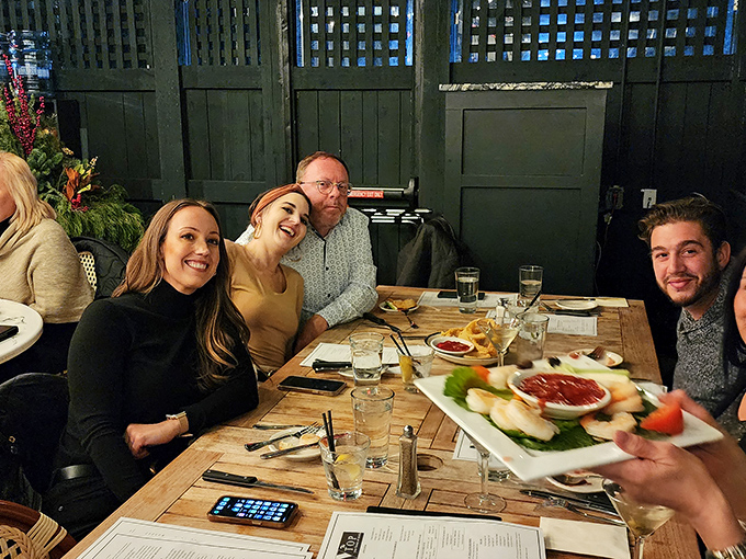 Happy diners sharing appetizers and stories—the universal language of good food bringing people together around the table.