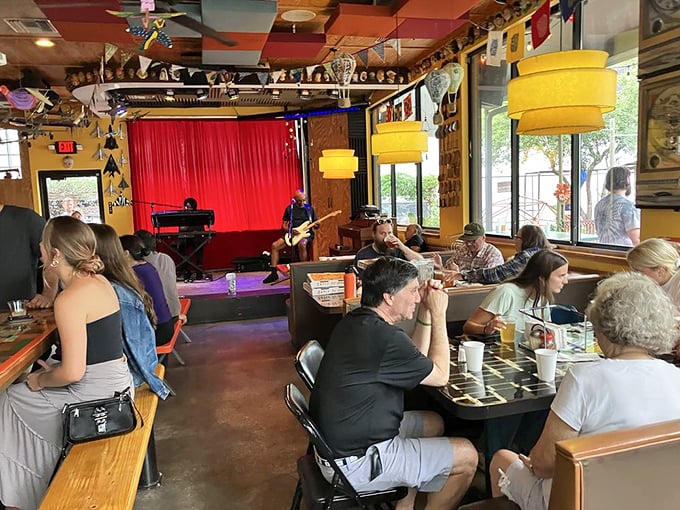Happy diners surrounded by controlled chaos, proving that atmosphere really does make everything taste better.