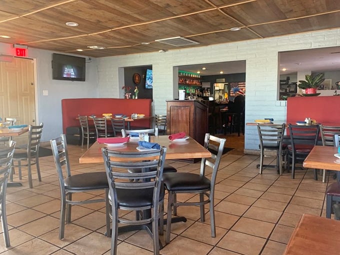 Red accents warm up this dining space where memories are made between bites. Those white brick walls have witnessed countless "mmm" moments.