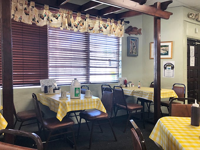 A dining area where chicken-themed curtains and wood beams create the perfect backdrop for morning conversations and coffee refills.