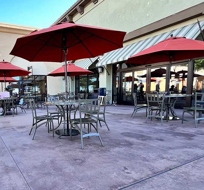 Outdoor dining areas with cheerful red umbrellas offer respite for weary shoppers—because bargain hunting burns more calories than you'd think.