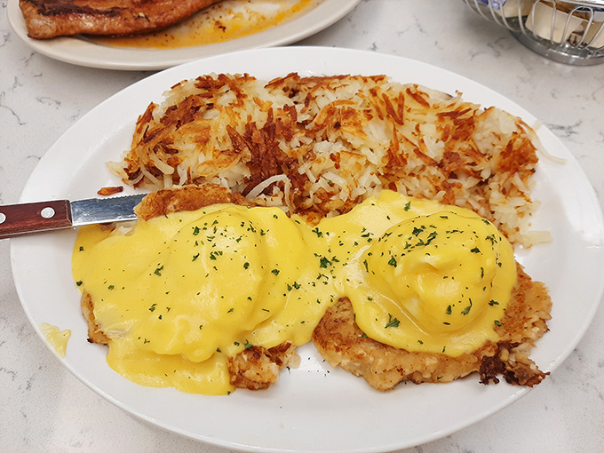 Eggs Benedict with hash browns crispy enough to make you forget whatever diet you promised to start tomorrow.