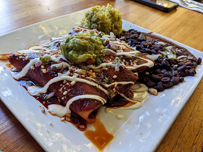 These enchiladas aren't just rolled tortillas—they're flavor torpedoes loaded with savory goodness and drizzled with sauce that demands to be savored.