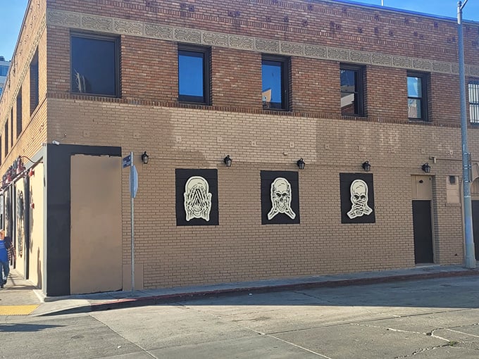 The exterior features stark silhouettes that hint at what awaits inside. Subtle art for a not-so-subtle subject.