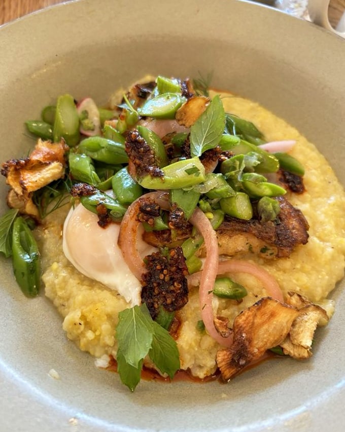 Grits and fish unite in delicious harmony, proving breakfast boundaries are meant to be broken.