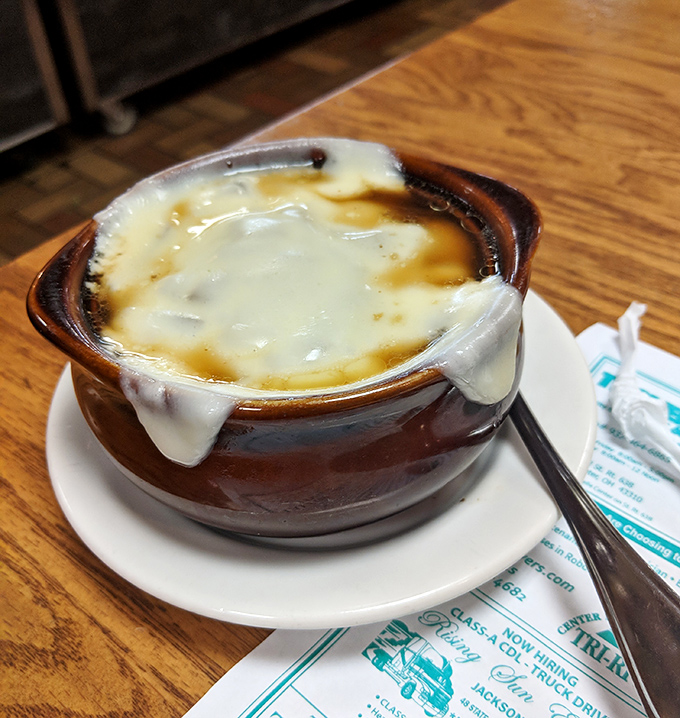 French onion soup with cheese stretching to the heavens—a bowl of savory comfort topped with a golden crown of broiled perfection.