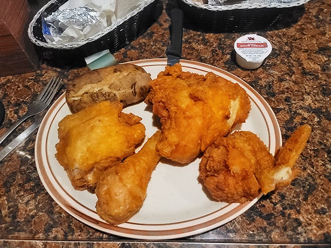 Golden-fried chicken that crackles with each bite, paired with a baked potato that's playing the perfect supporting role.