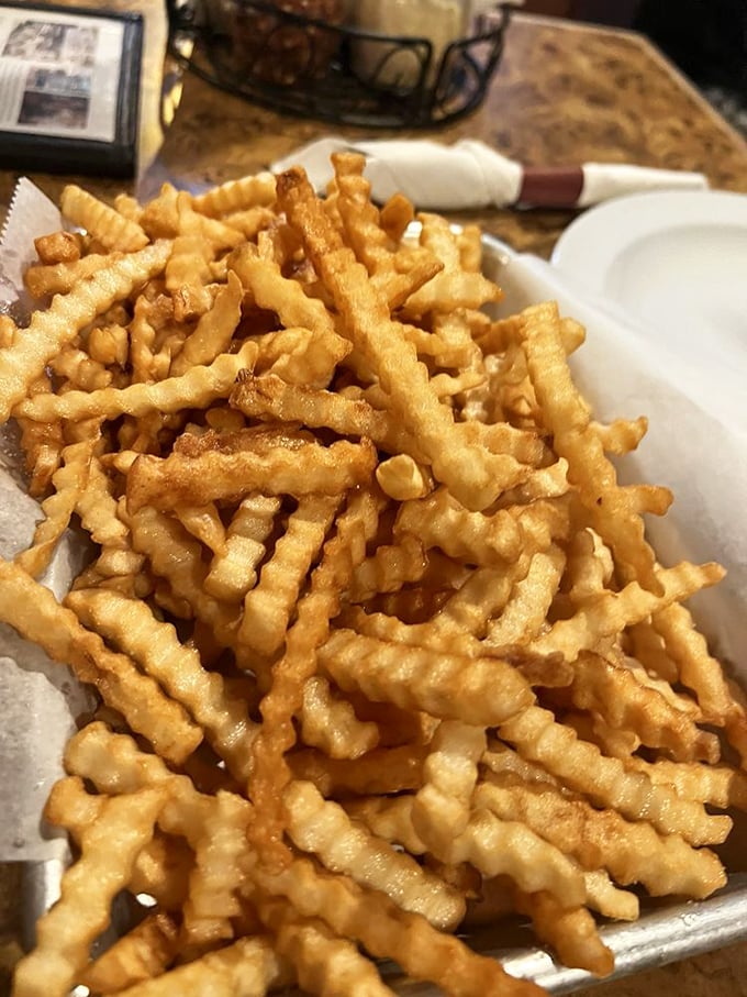 Crinkle-cut fries that achieve the impossible: crispy exterior, fluffy interior, and seasoned just enough to make you forget ketchup exists.