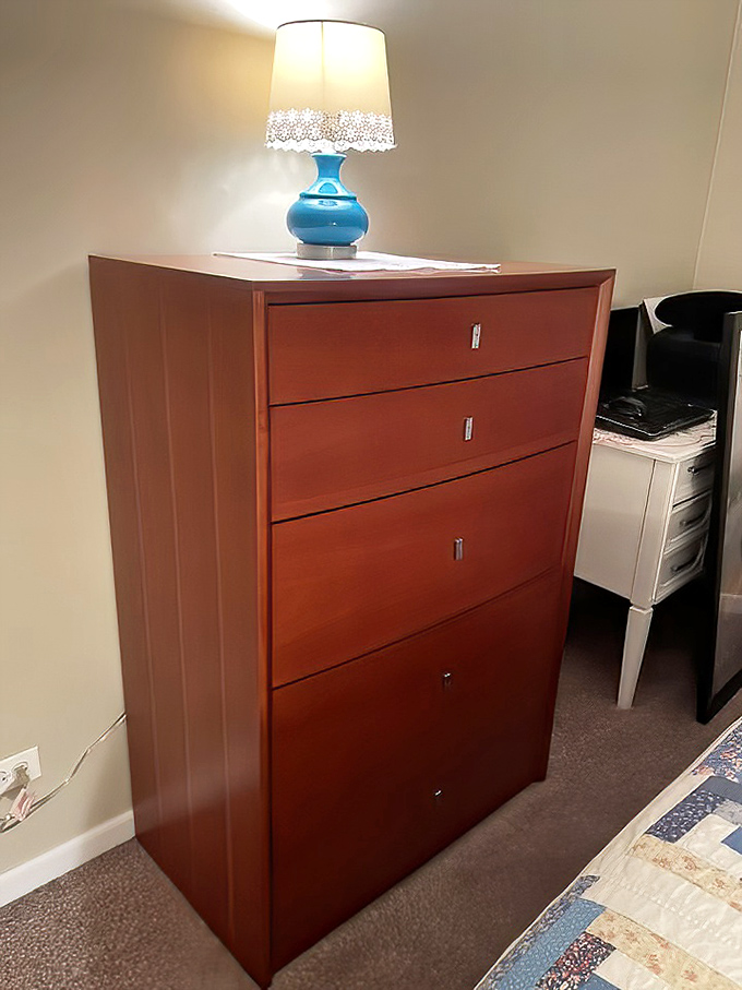 This isn't just a dresser—it's five drawers of possibility, a mahogany-toned blank slate ready for its second chapter in your bedroom.