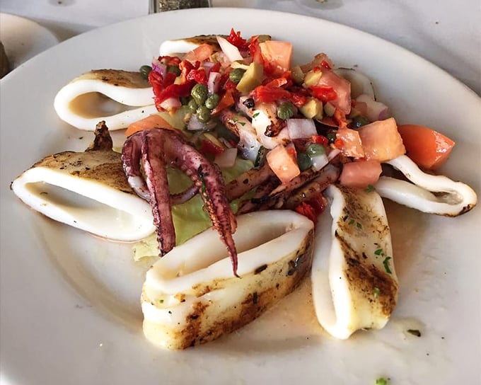 Grilled calamari that's tender, not rubbery—the unicorn of seafood appetizers, complete with vibrant salsa.