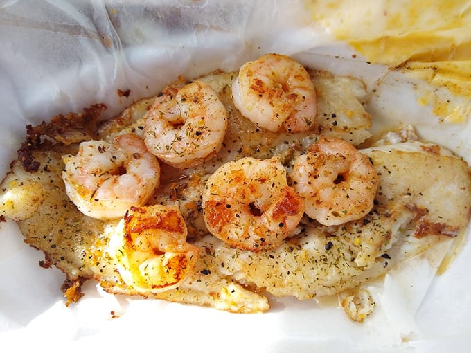 Succulent grilled shrimp nestled against flaky white fish—a seafood duet that sings with simple seasoning and perfect execution.
