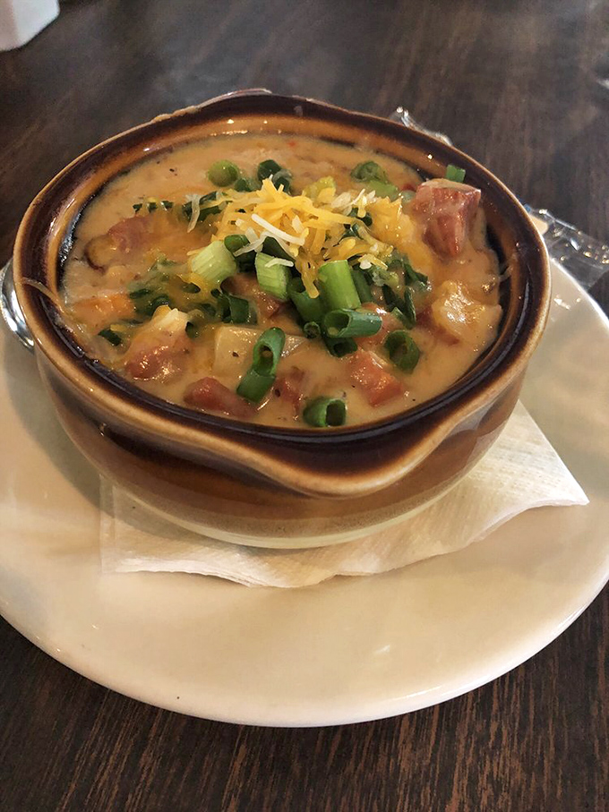 A hearty soup that's practically a meal, topped with green onions and cheese—the kind of dish that makes Cleveland winters almost bearable.